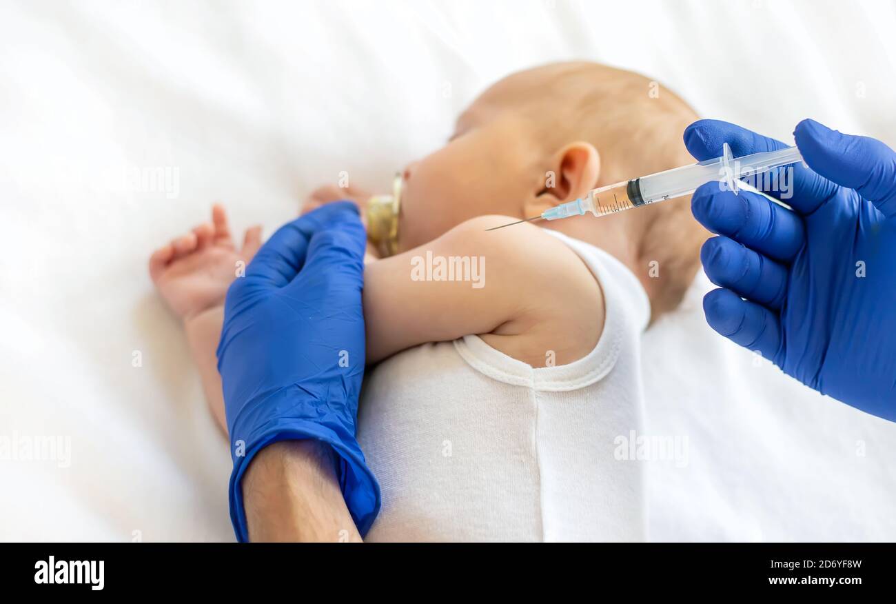 Vaccination baby, injection in the arm. Selective focus. People Stock ...