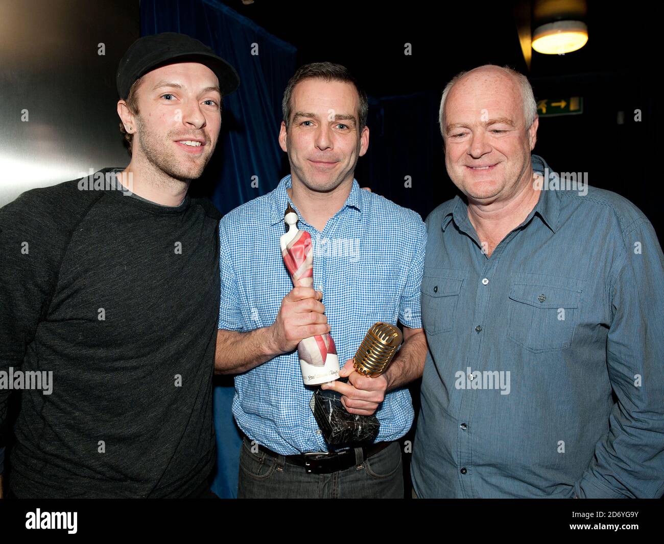(l-r) Chris Martin, Producer of the Year Brit award winner Marcus Dravs ...