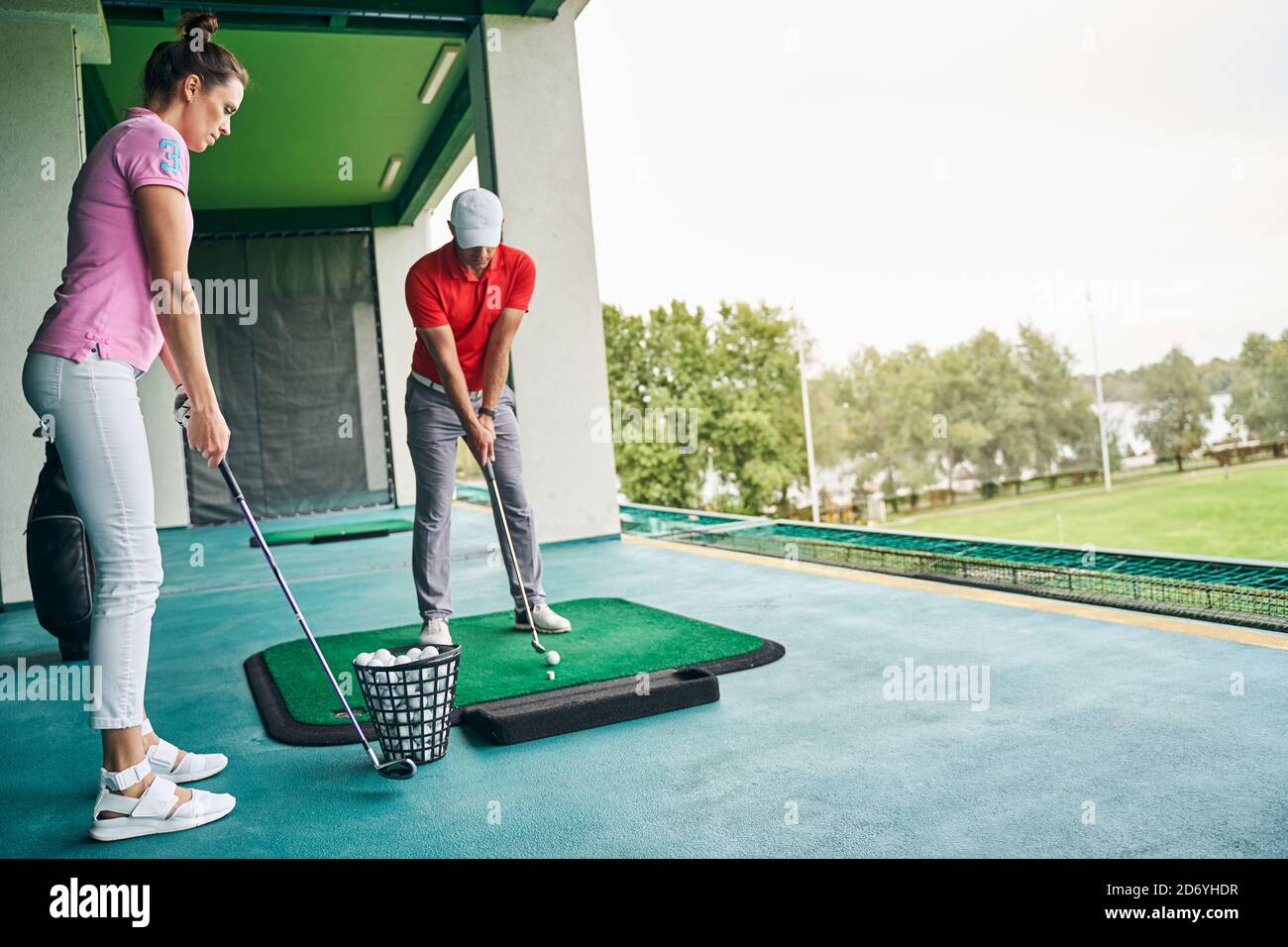 Professional golf trainer demonstrating a putting stroke Stock Photo ...