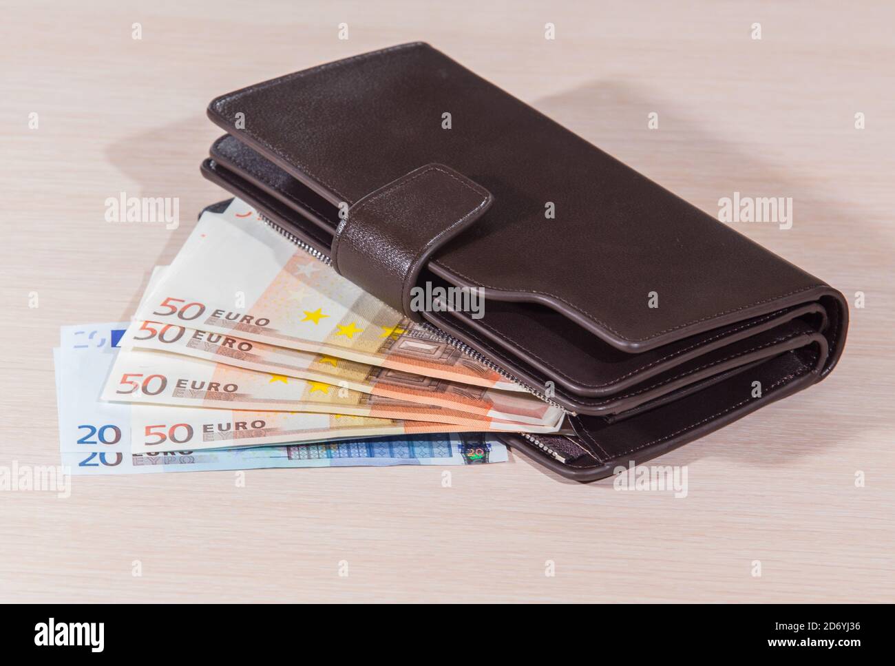 euro banknotes in brown leather purse Stock Photo - Alamy