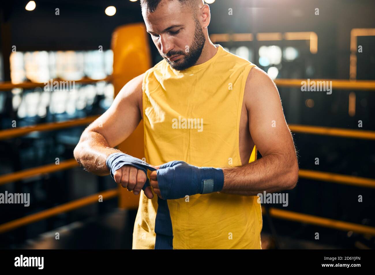 Concentrated athletic person binding his right hand Stock Photo - Alamy