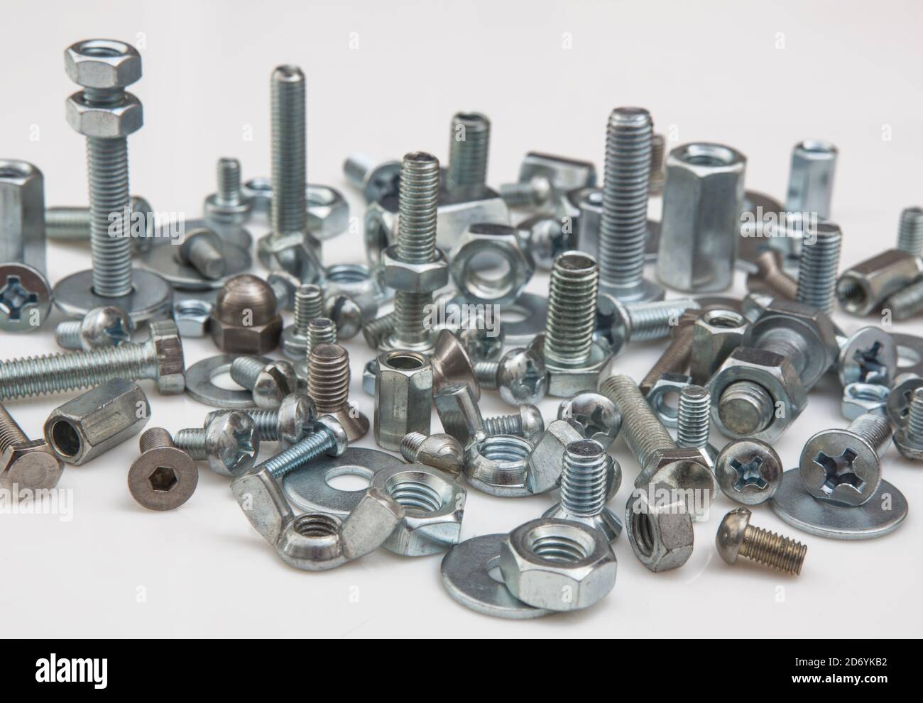 chromeplated bolts and nuts on white background Stock Photo - Alamy