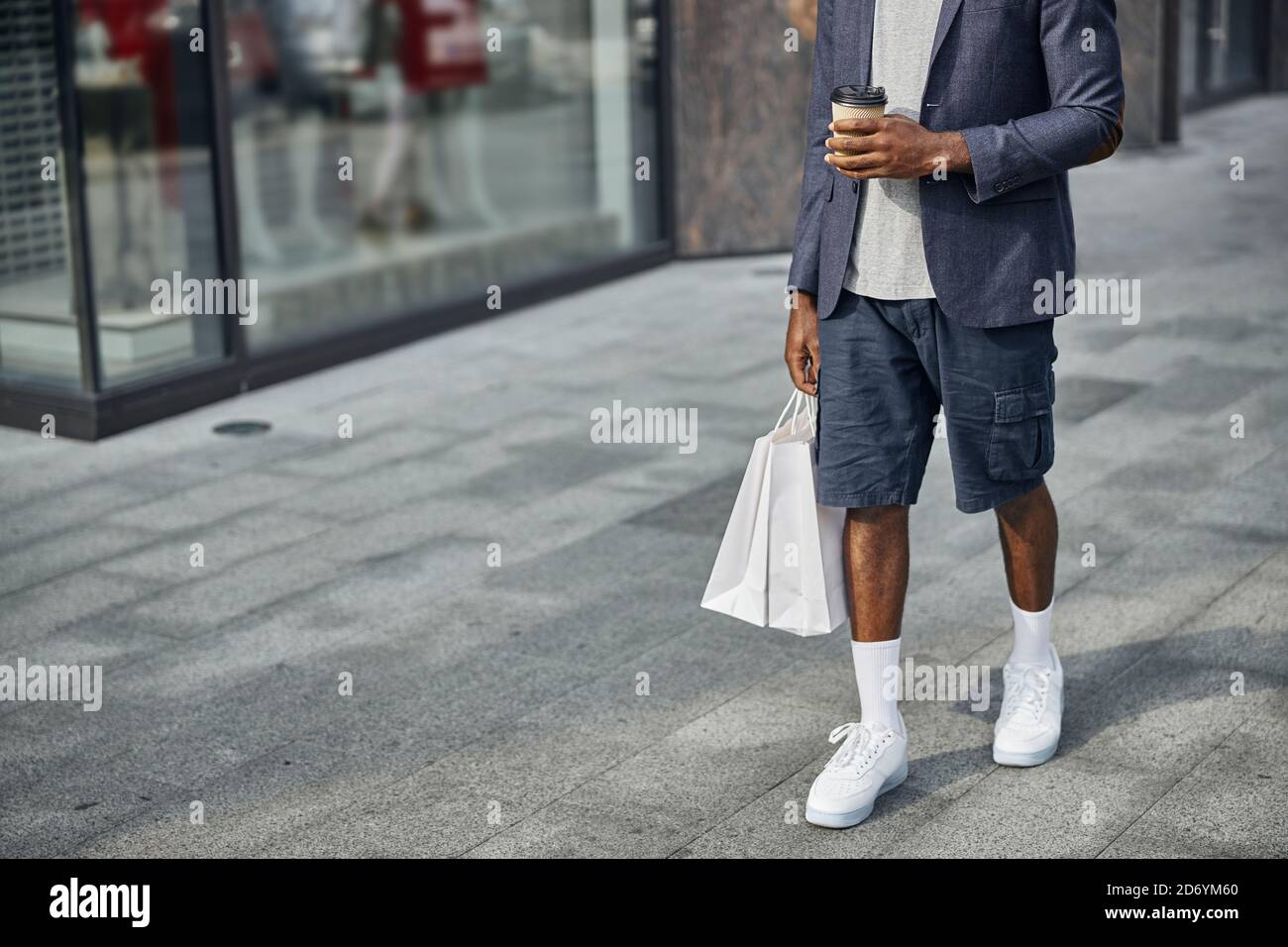 Close up of young man holding paper cup Stock Photo - Alamy