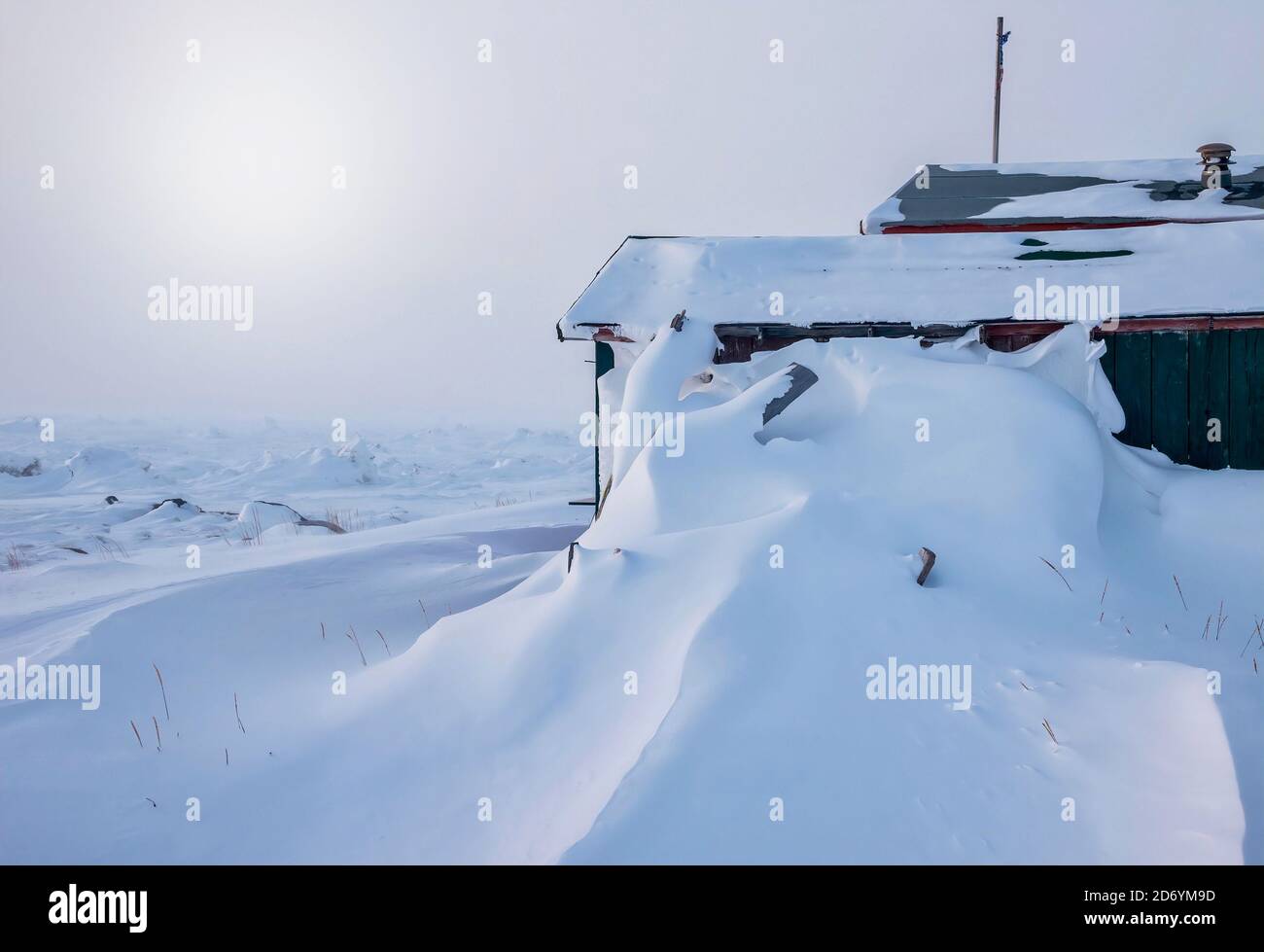 Deep snowdrifts piled high against the side of a house after a winter ...