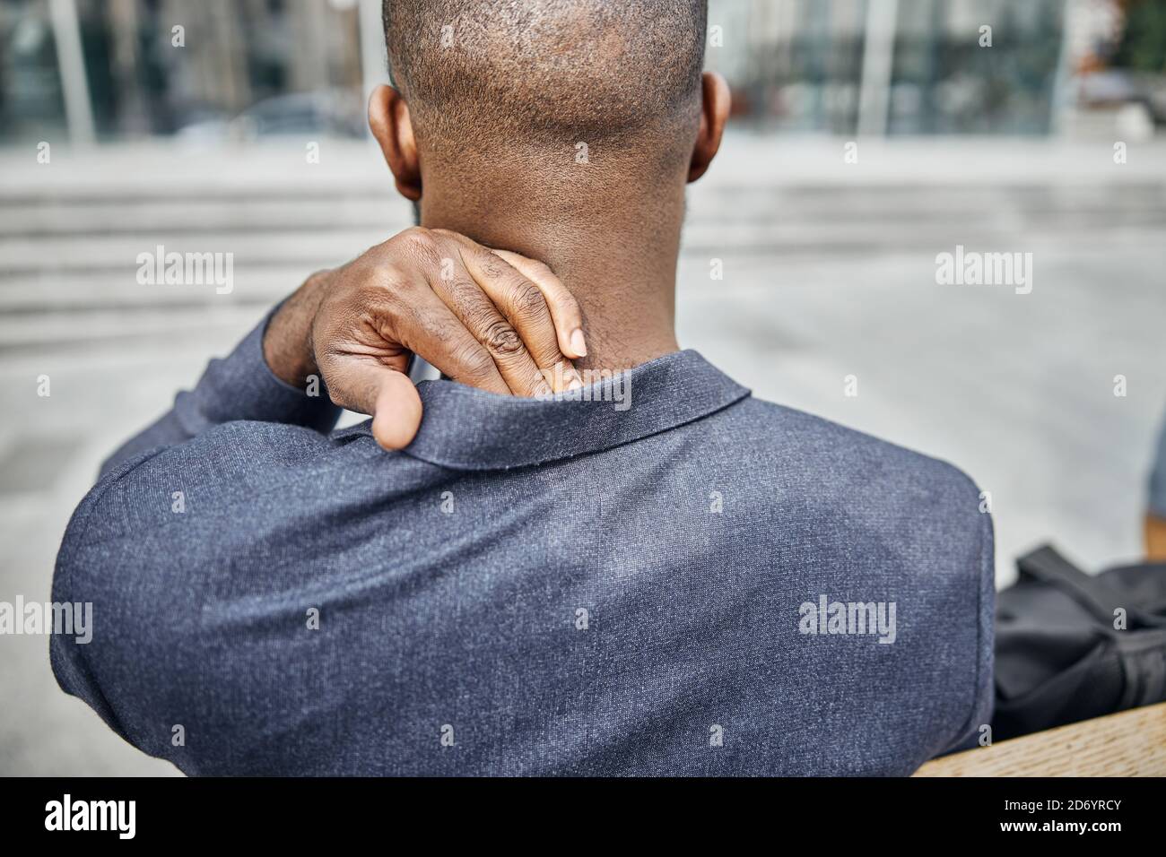 Focused photo on male hand touching neck Stock Photo - Alamy