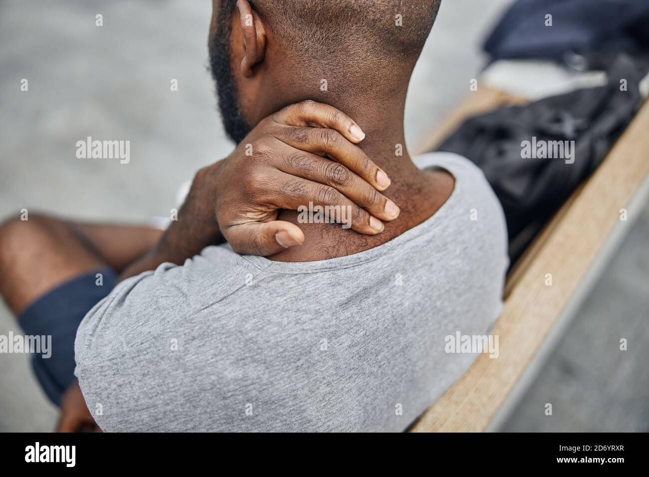 Focused photo on male hand that touching neck Stock Photo - Alamy