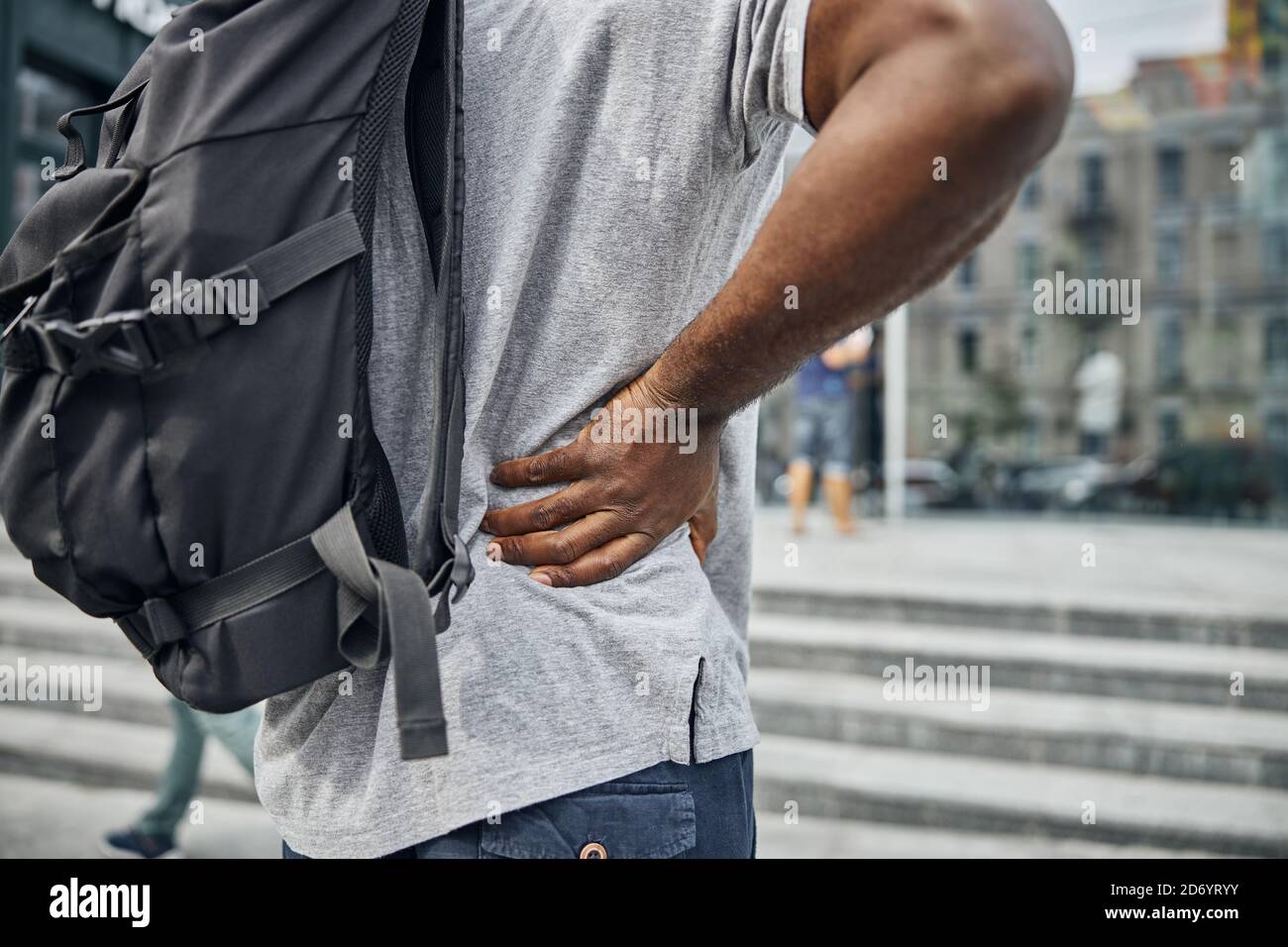 Close up of male person touching his back Stock Photo - Alamy
