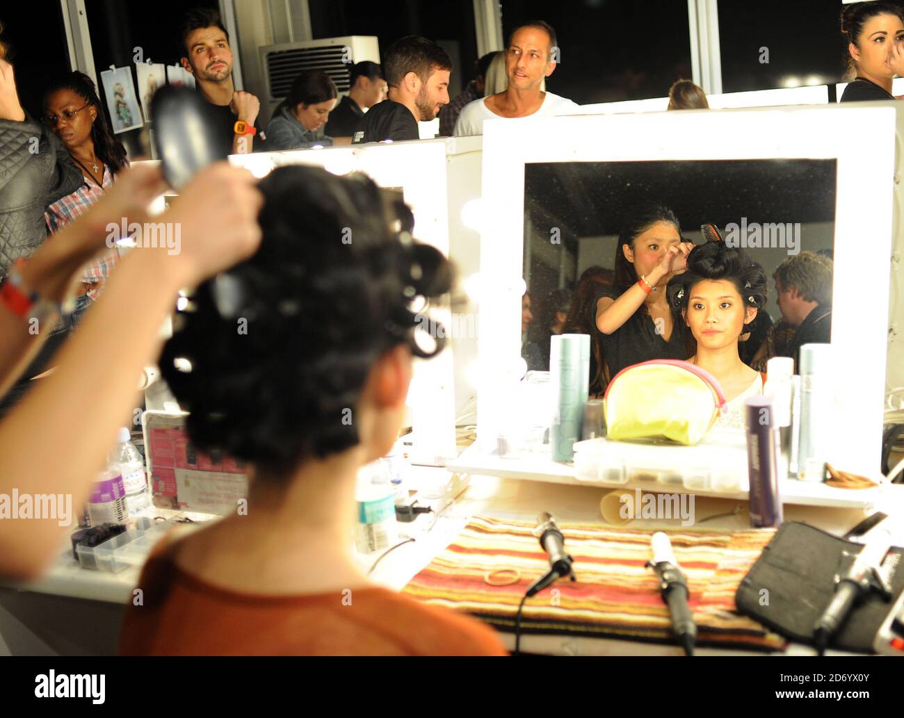 Models get their hair and makeup done for the Issa fashion show, held ...