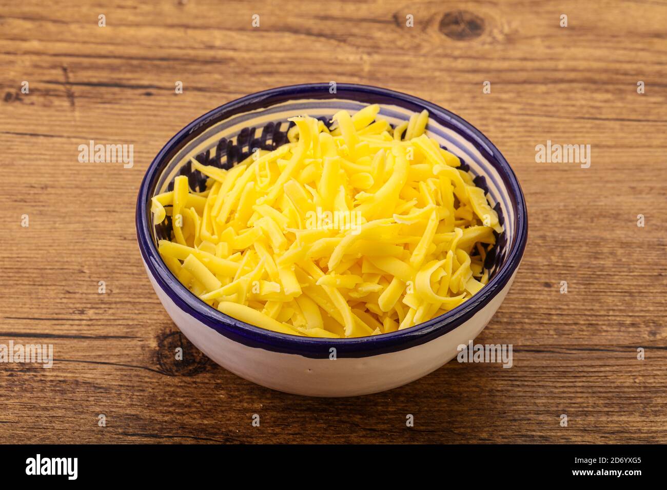 Shredded yellow cheese in the bowl for cooking Stock Photo - Alamy