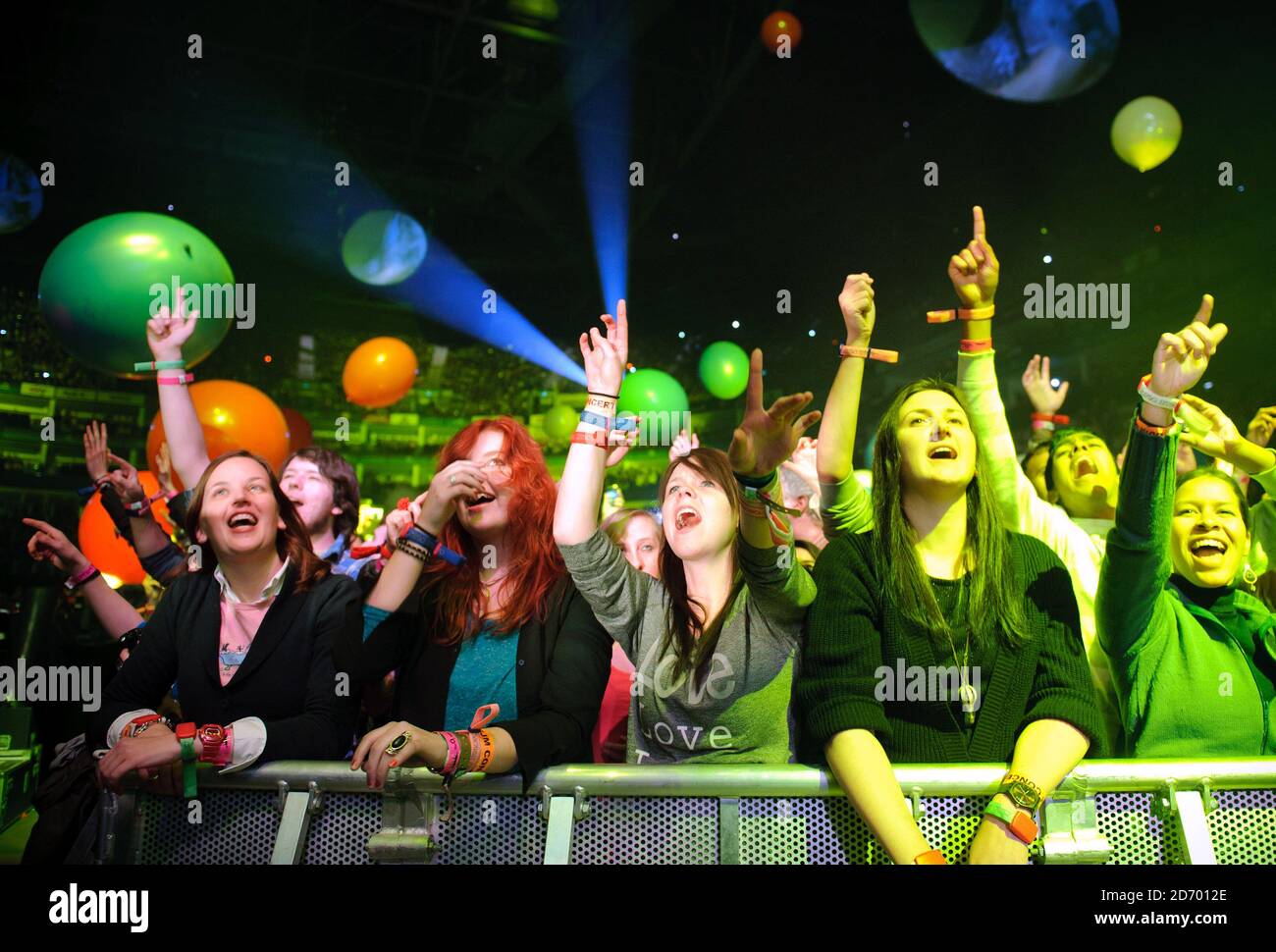 The crowd watch Coldplay performing at Under One Roof, a charity ...