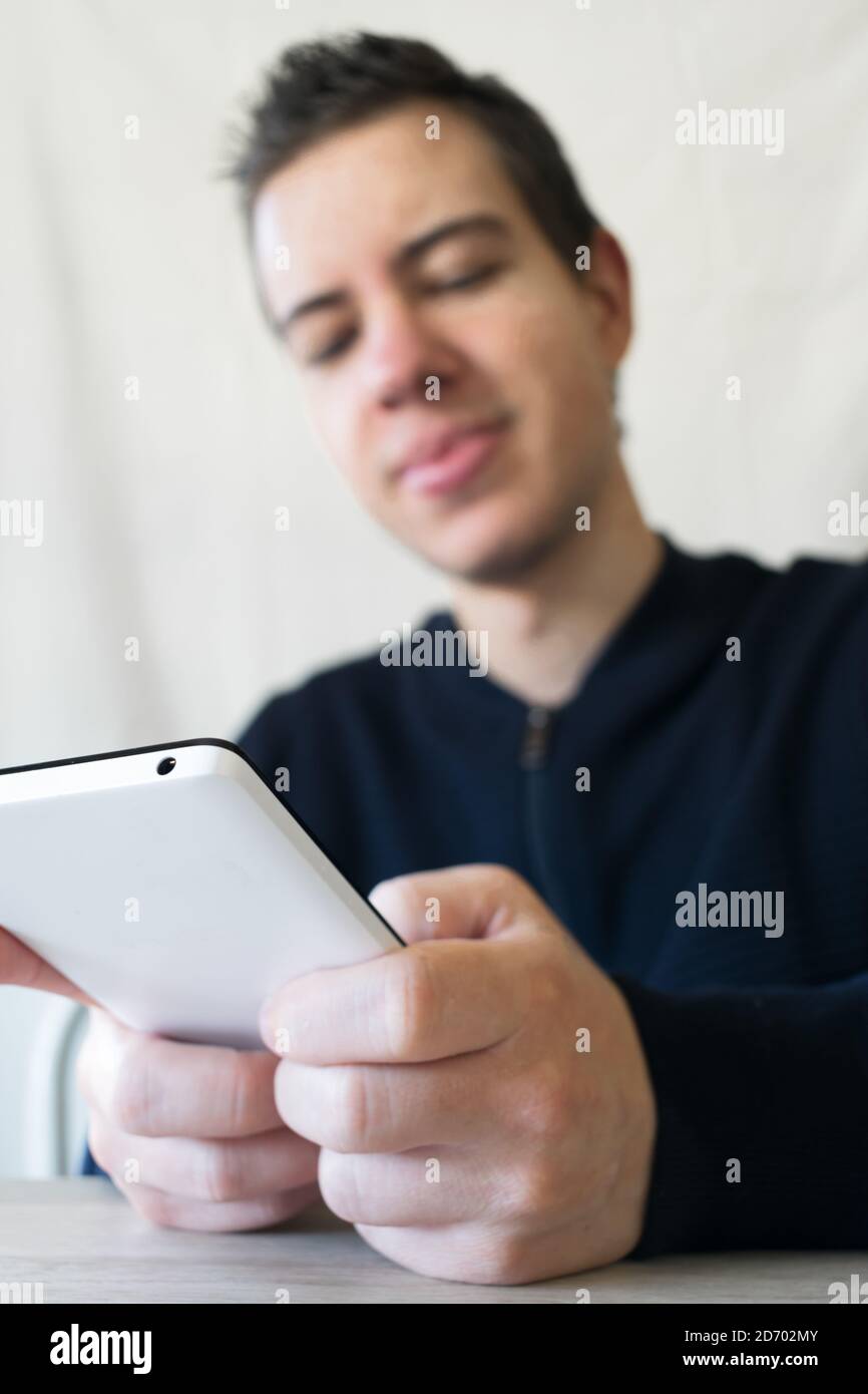 Caucasian young man using his mobile phone Stock Photo - Alamy