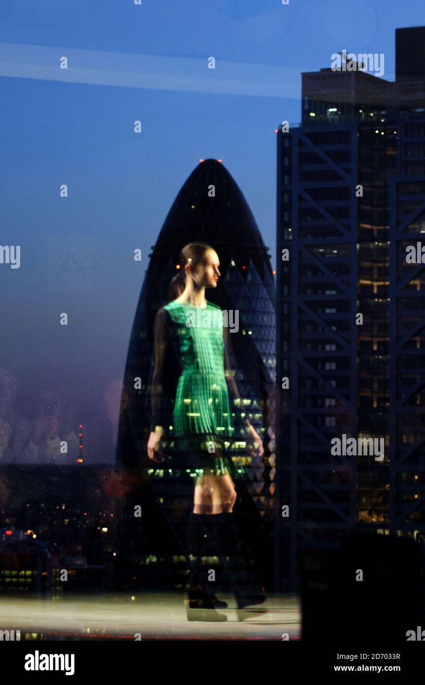 Models on the catwalk are reflected in the windows at the Jonathan ...