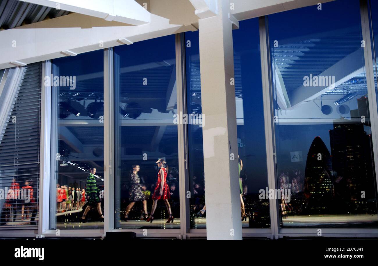 Models on the catwalk are reflected in the windows at the Jonathan ...