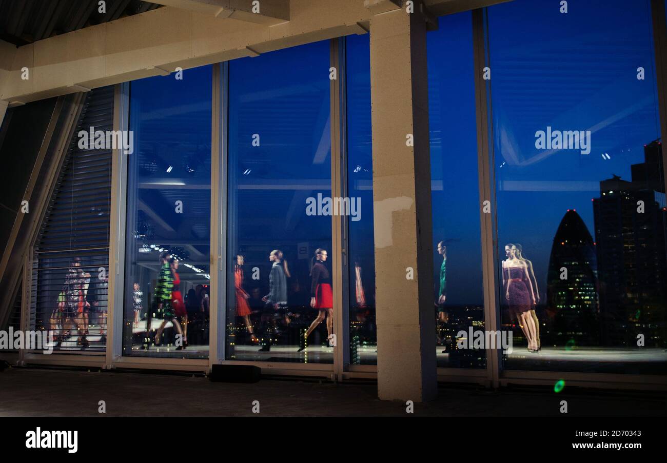 Models on the catwalk are reflected in the windows at the Jonathan ...