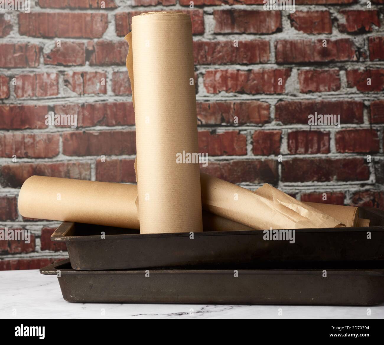 rolls of brown parchment paper on a white table, brown brick wall Stock ...