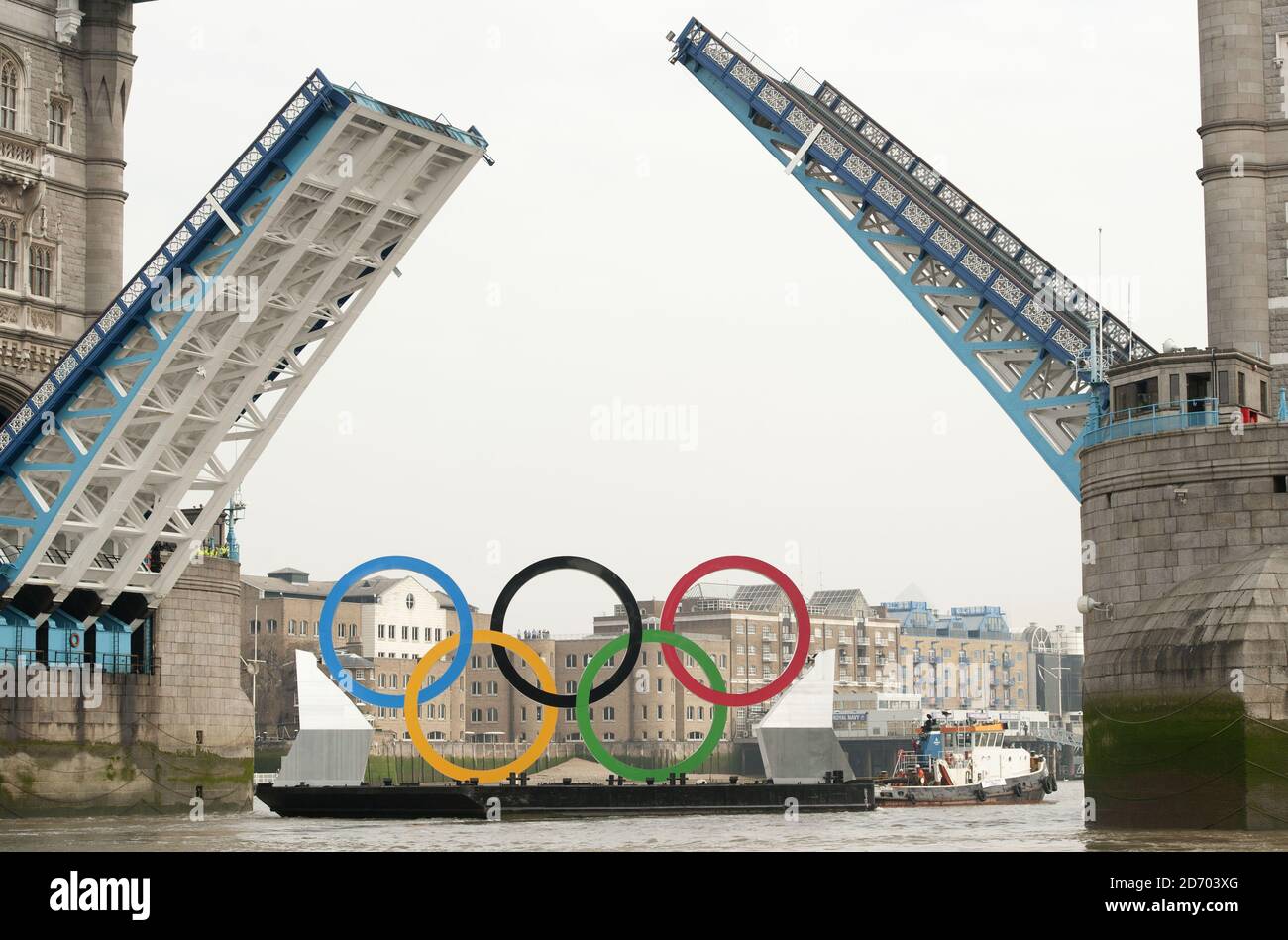 Giant Olympic rings are floated down the river Thames, to mark 150 days ...
