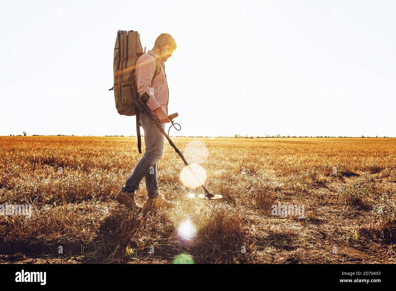 Man with metal detector equipment searching for metal goods in the ...