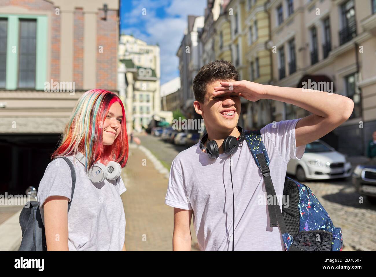 Portrait of talking students teenagers boy and girl in city looking ...