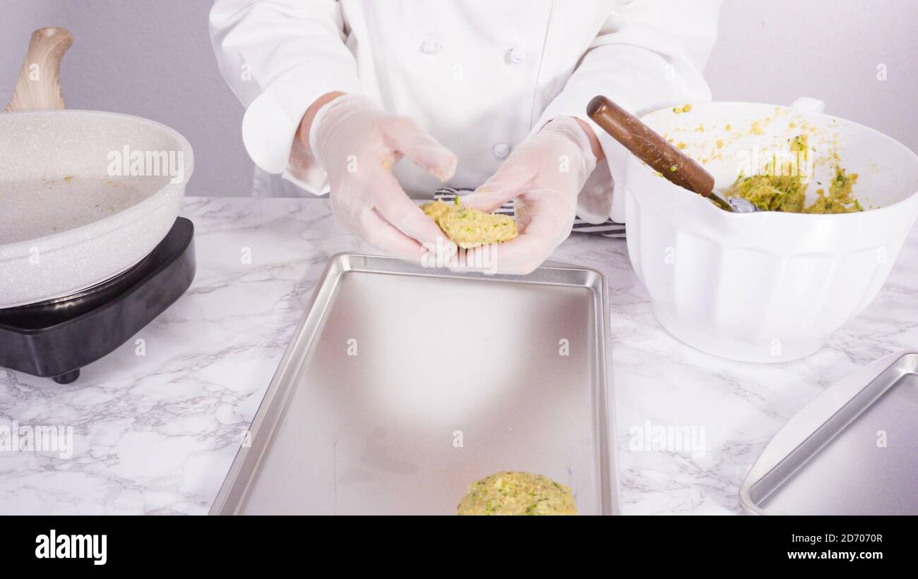 Step by step. Shaping patties of zucchini cakes to fry on a frying pan ...
