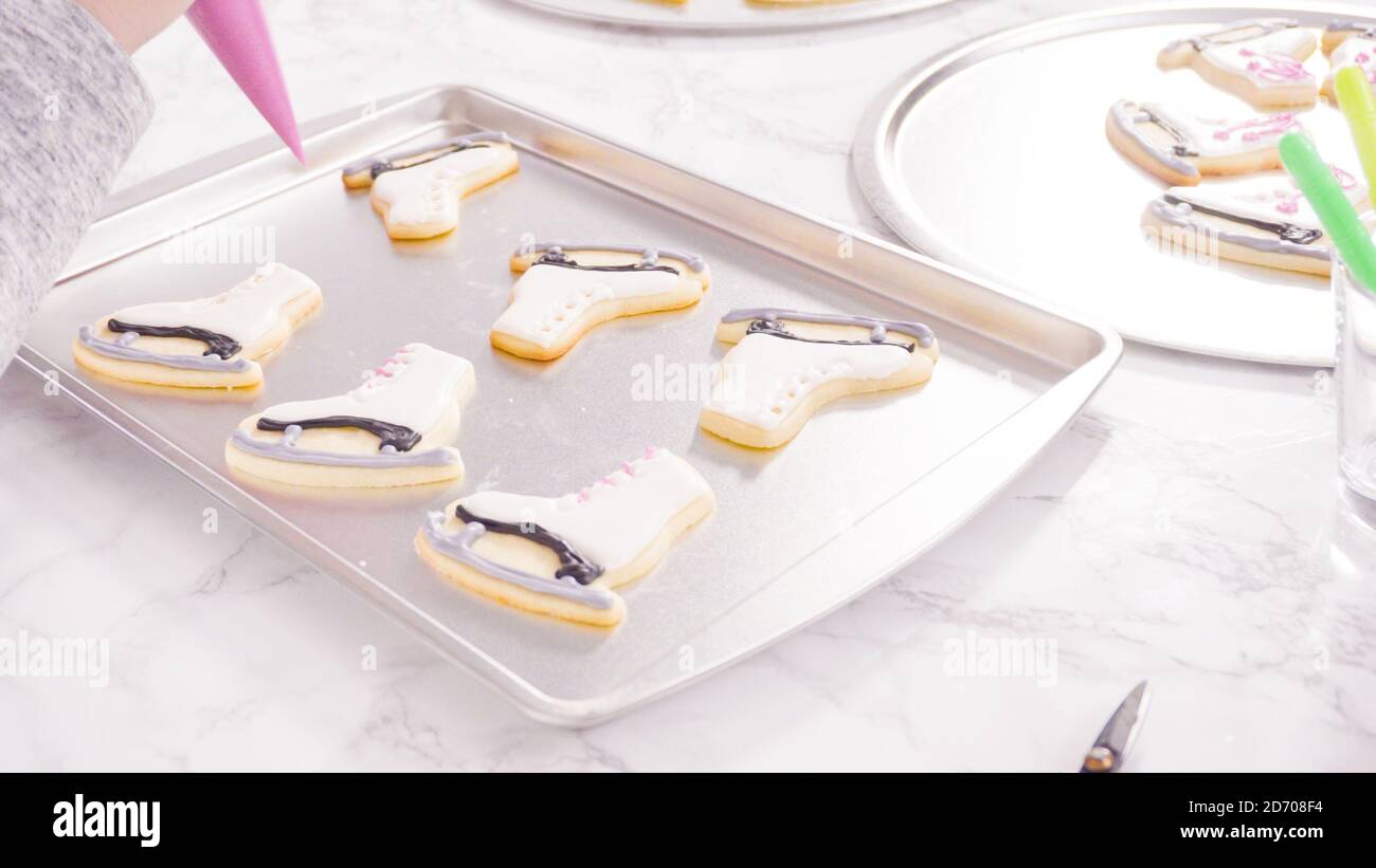 Icing figure skate shaped sugar cookies with royal icing Stock Photo ...