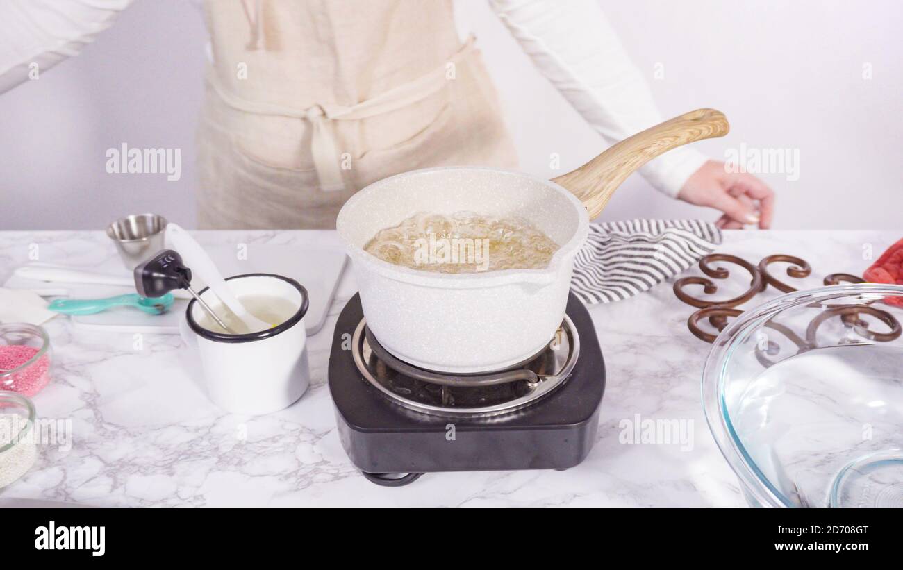 Step by step. Caramelizing sugar in a small cooking pot over the small ...