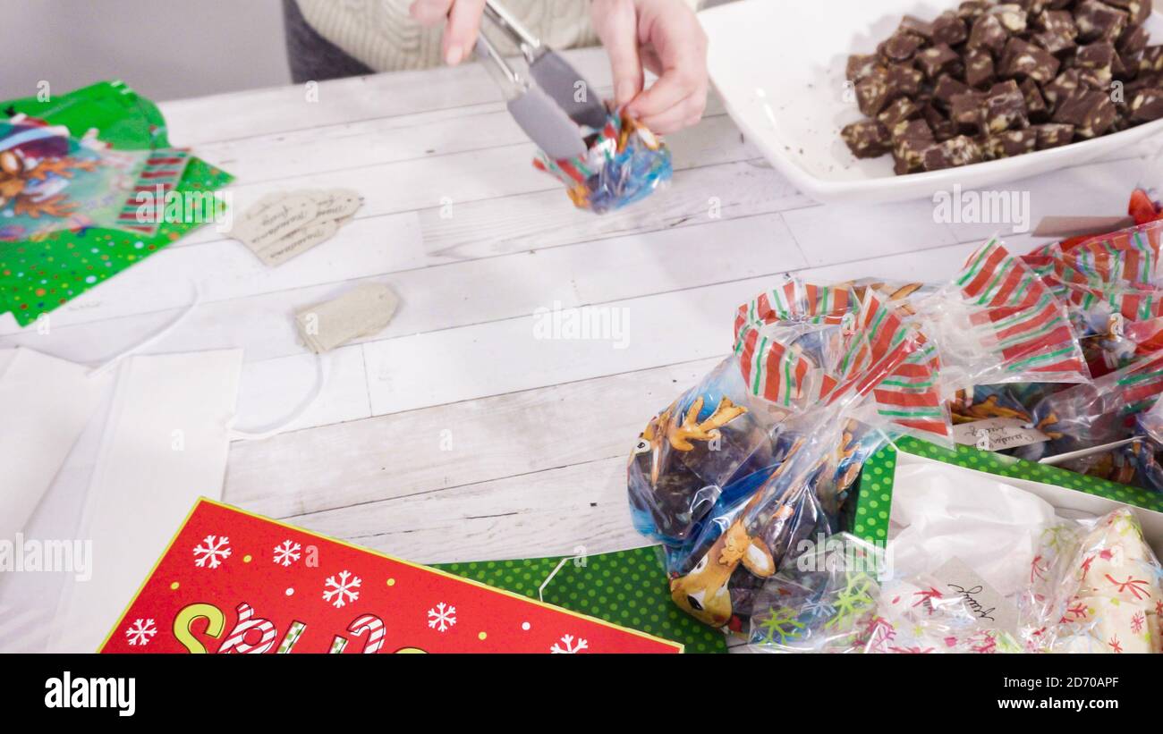 Step by step. Packaging homemade fudge and cookies into a Christmas ...