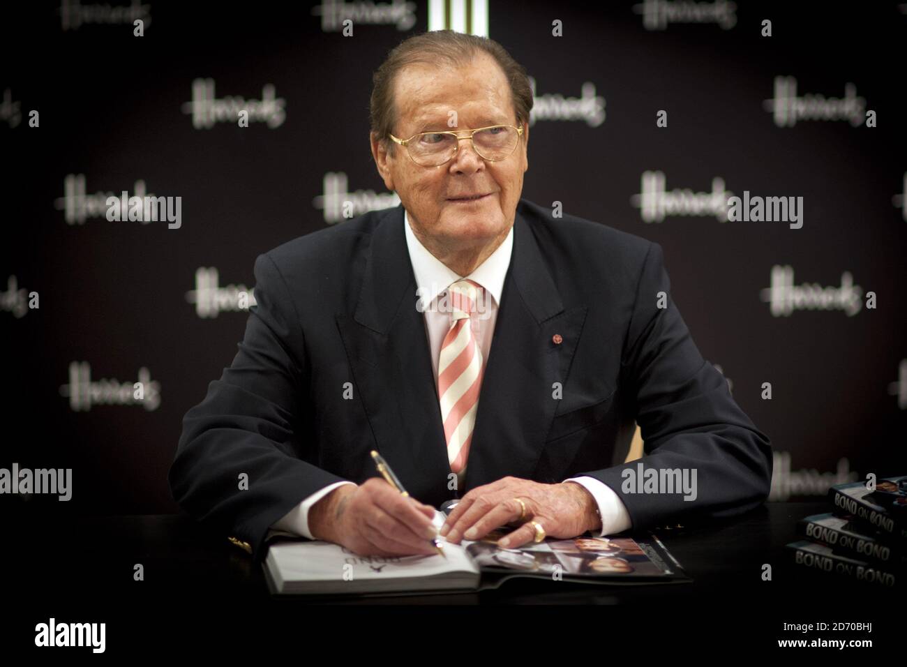 Roger Moore signs copies of his book, Bond on Bond, at Harrod's in West ...