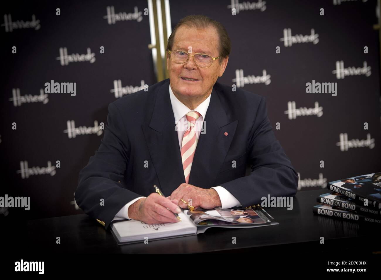 Roger Moore signs copies of his book, Bond on Bond, at Harrod's in West ...