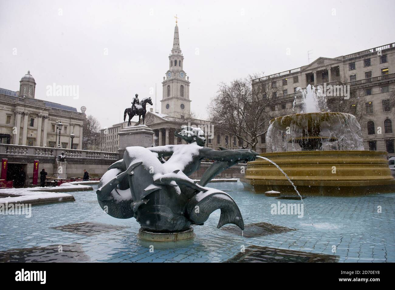Snow covers the statues in Trafalgar Square, London, as cold weather ...