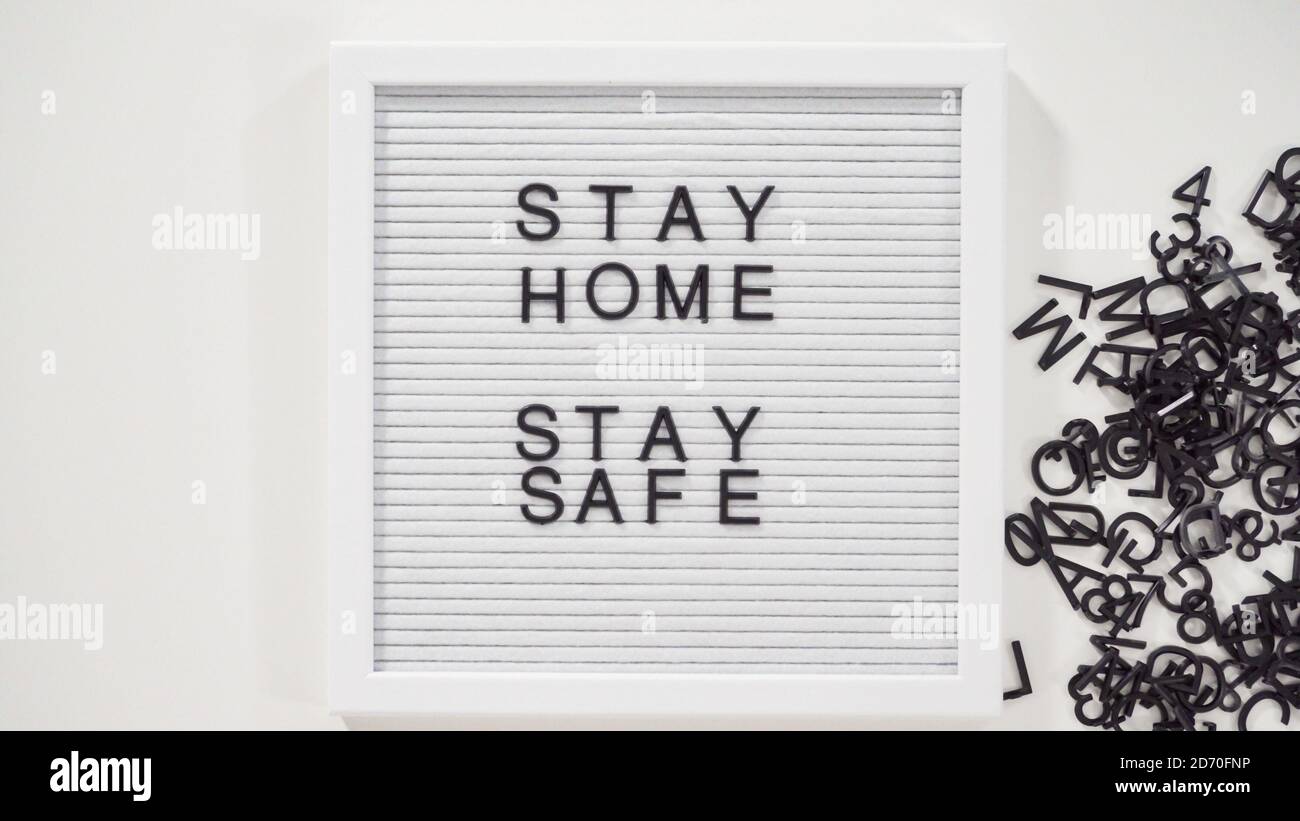 Flat lay. STAY HOME and STAY SAFE sign on a white message board Stock ...