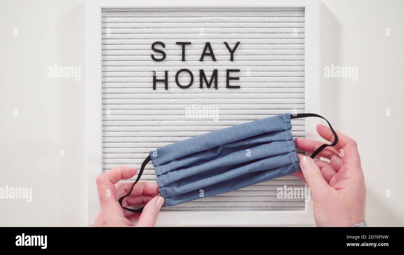 Flat lay. STAY HOME and STAY SAFE sign on message board with a homemade ...