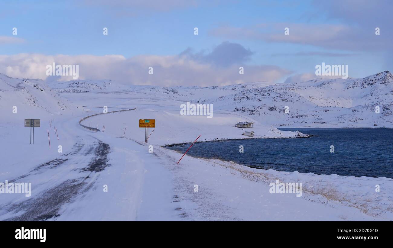 Icy road E69 with road sign displaying distance to Nordkapp (45km) near ...