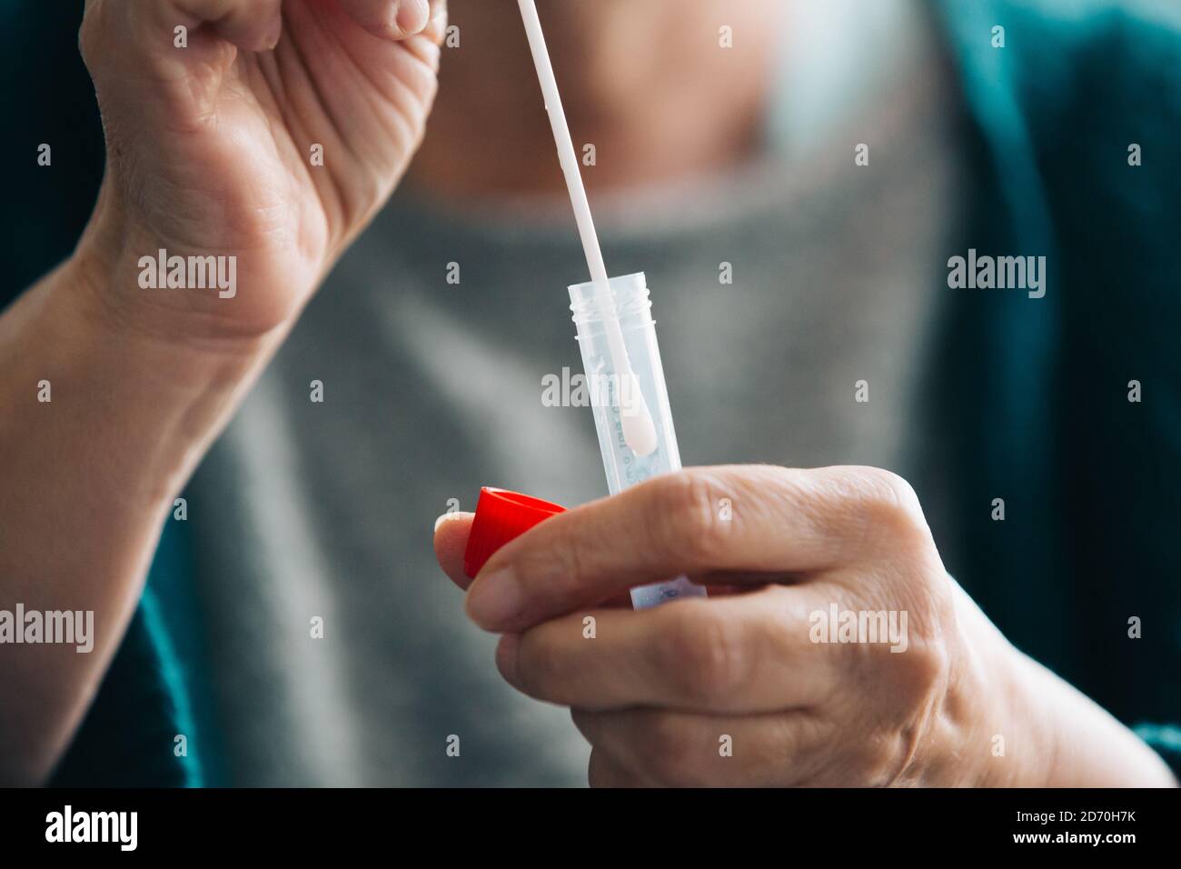 Senior woman performing a swab test for coronavirus covid-19 and ...
