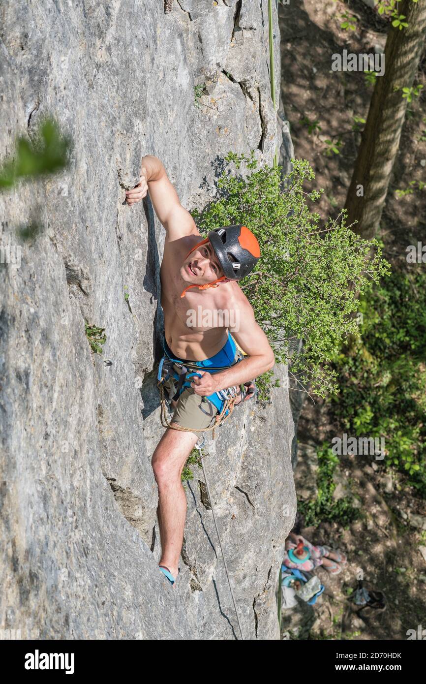 Male climber focused on the next step on a limestone wall Stock Photo ...