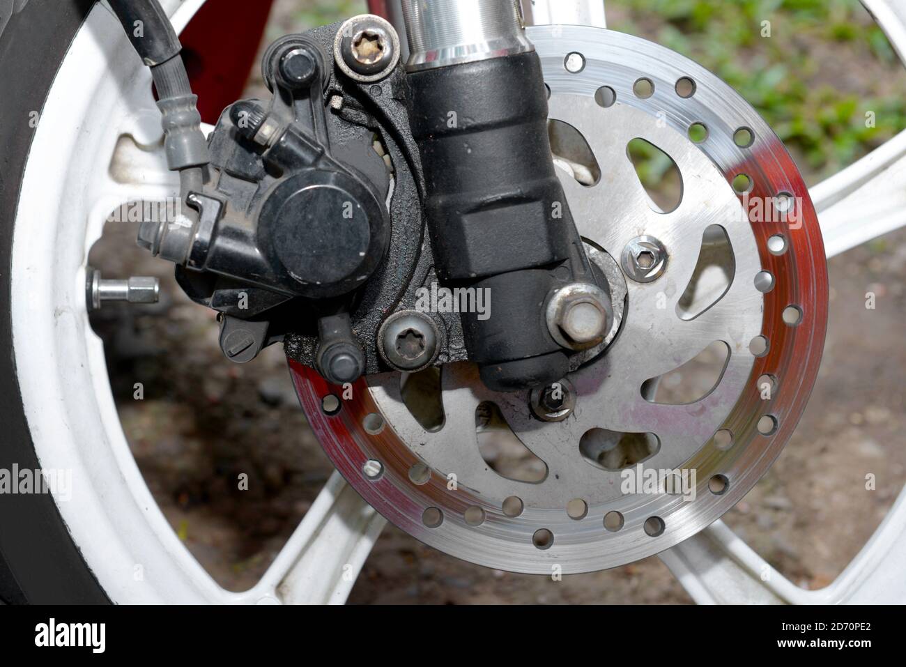 Close up view of motorcycle wheel and disc brake in front of the ...