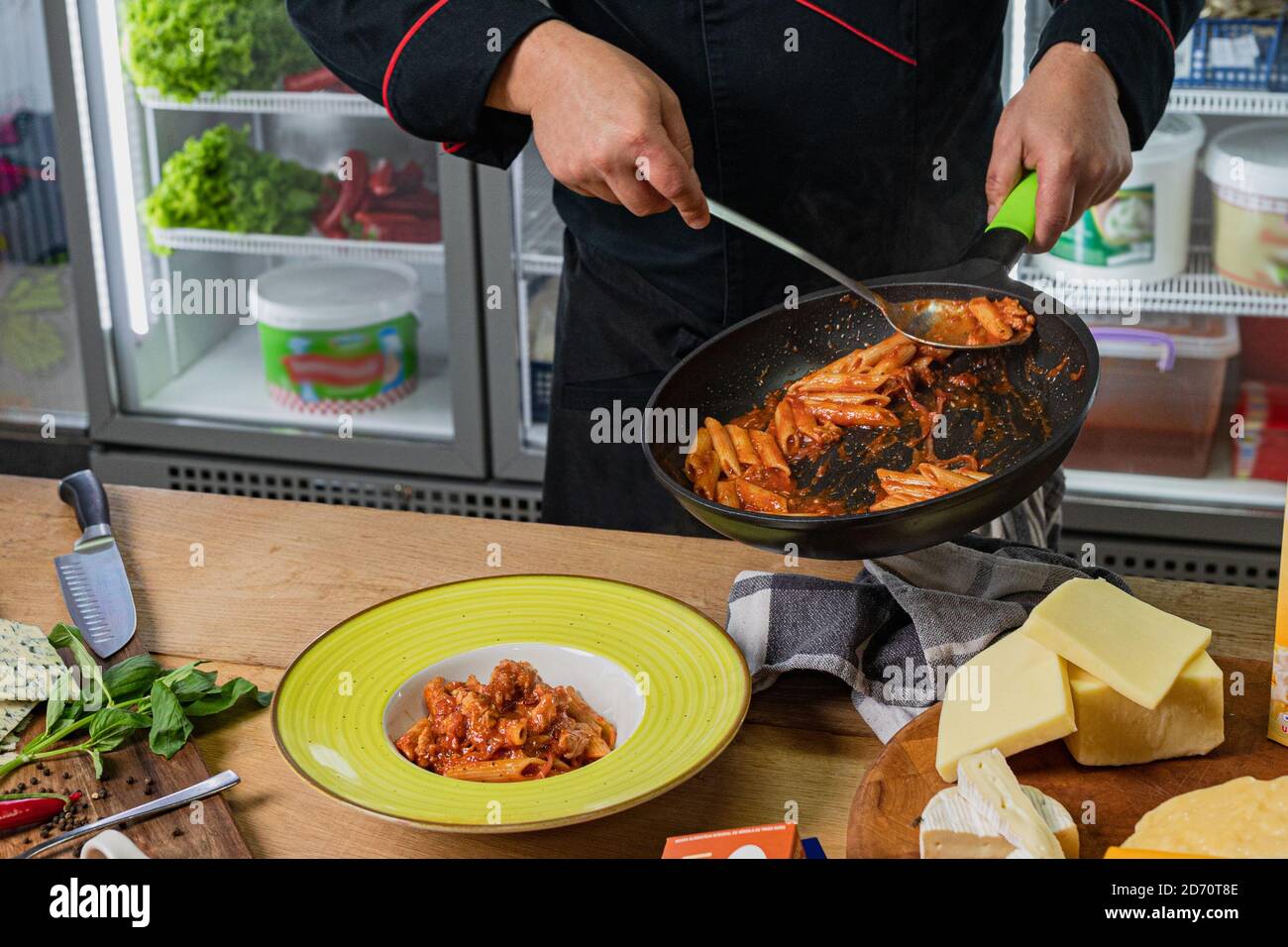 The chef puts pasta from the pan and do the plating Stock Photo - Alamy