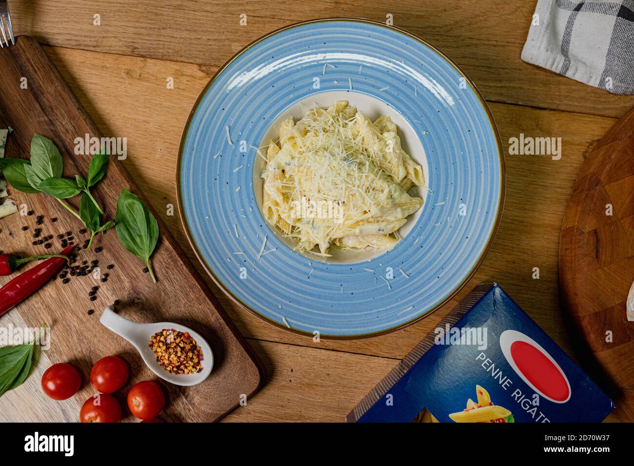 Penne Quatro Formaggi on wooden table with ingredients next to it ...