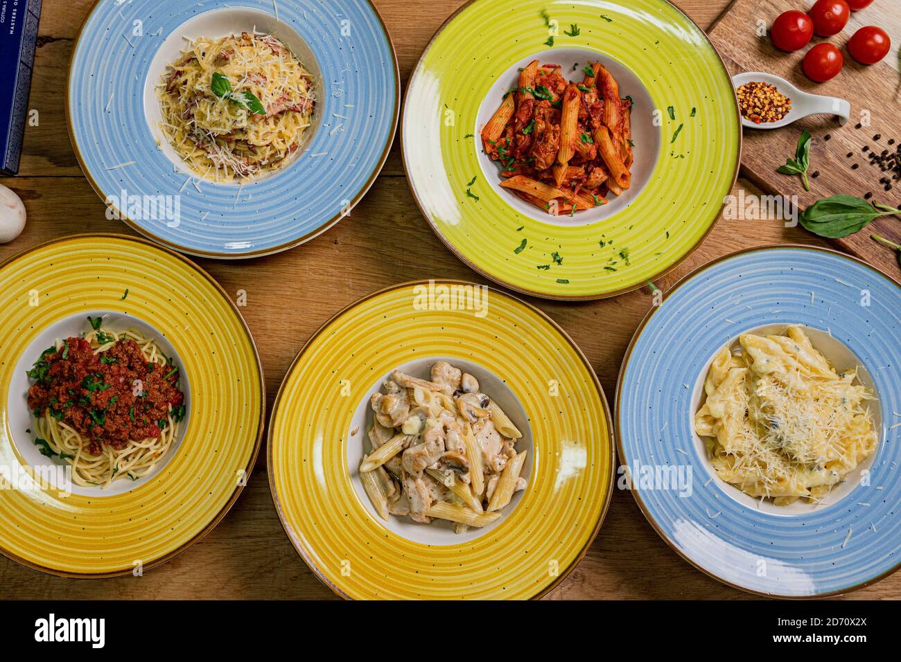 Several plates of pasta & spaghetii with different kinds of sauce over ...