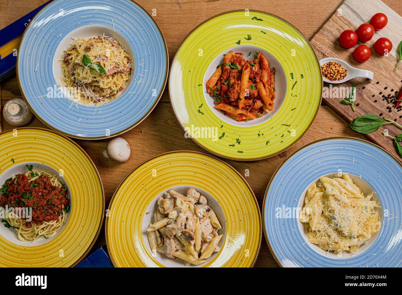 Several plates of pasta & spaghetii with different kinds of sauce over ...