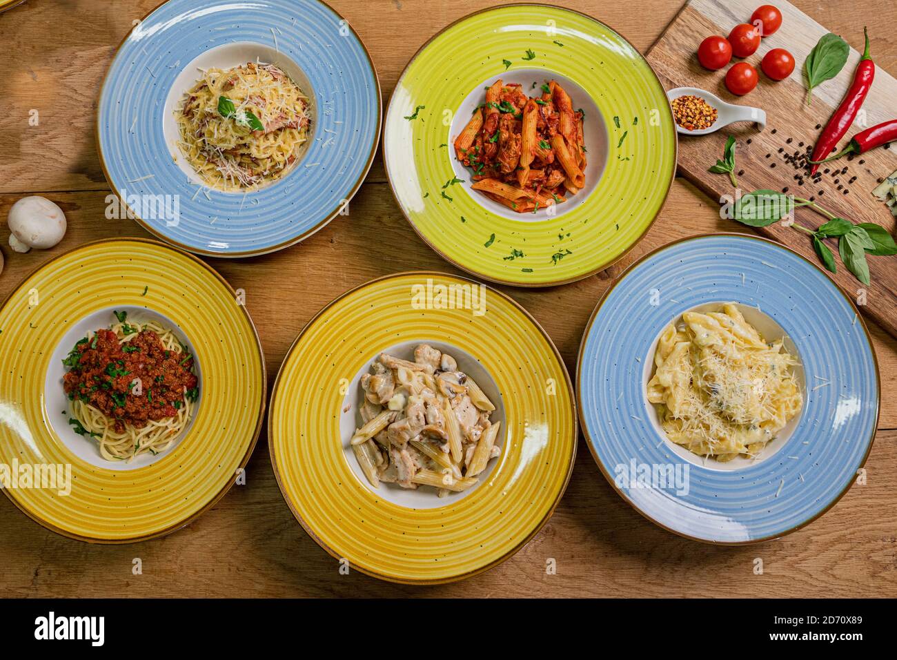 Several plates of pasta & spaghetii with different kinds of sauce over ...