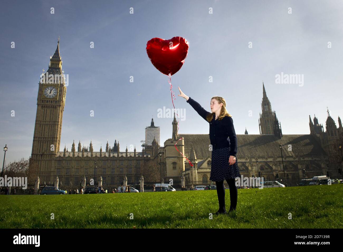 A girl takes part in a global recreation of Banksy's â€œGirl with Red ...