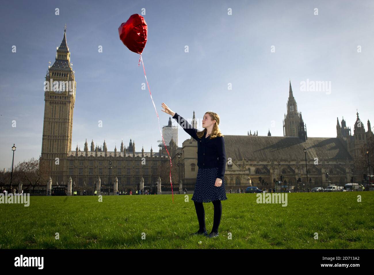 A girl takes part in a global recreation of Banksy's â€œGirl with Red ...