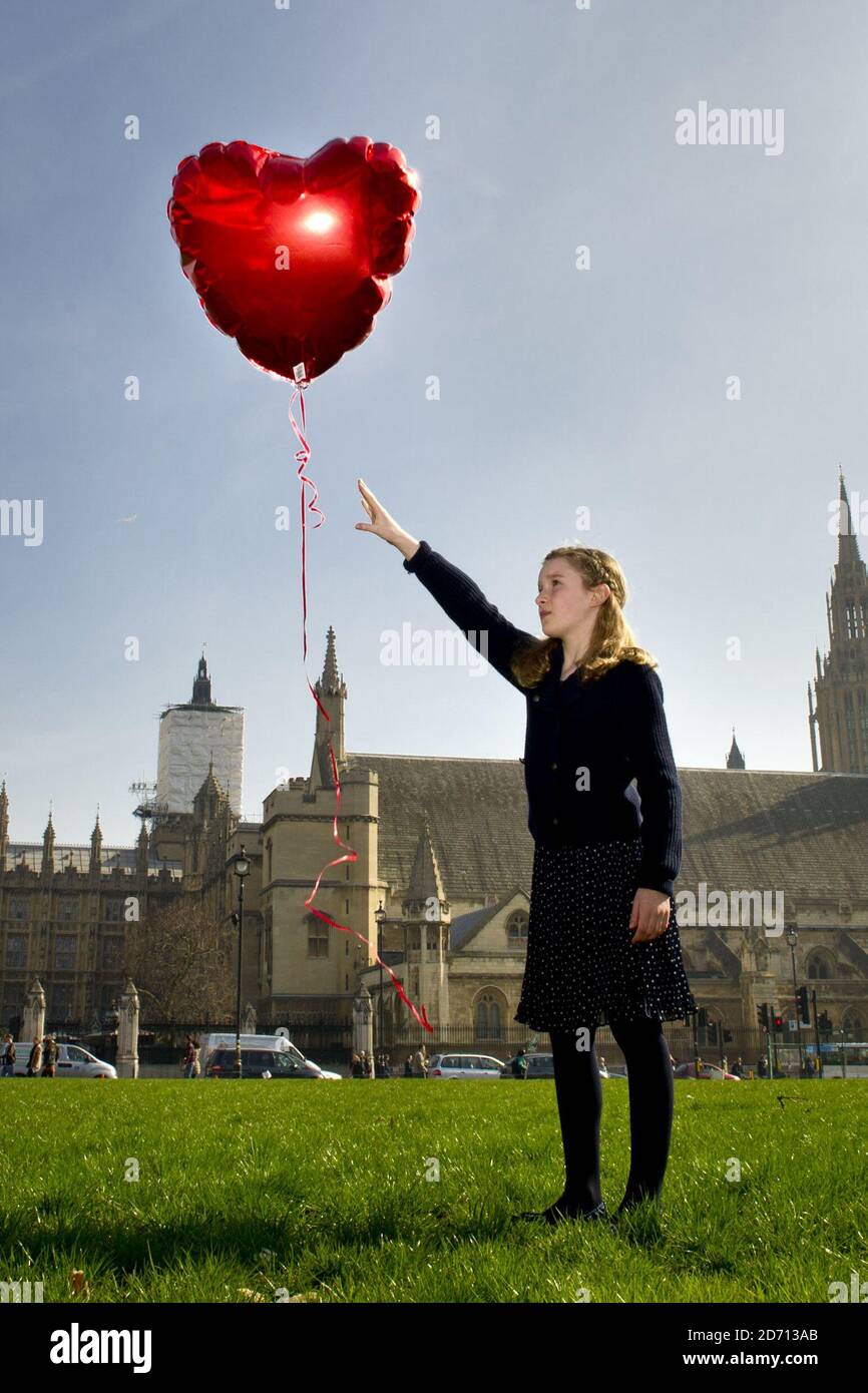 A girl takes part in a global recreation of Banksy's â€œGirl with Red ...