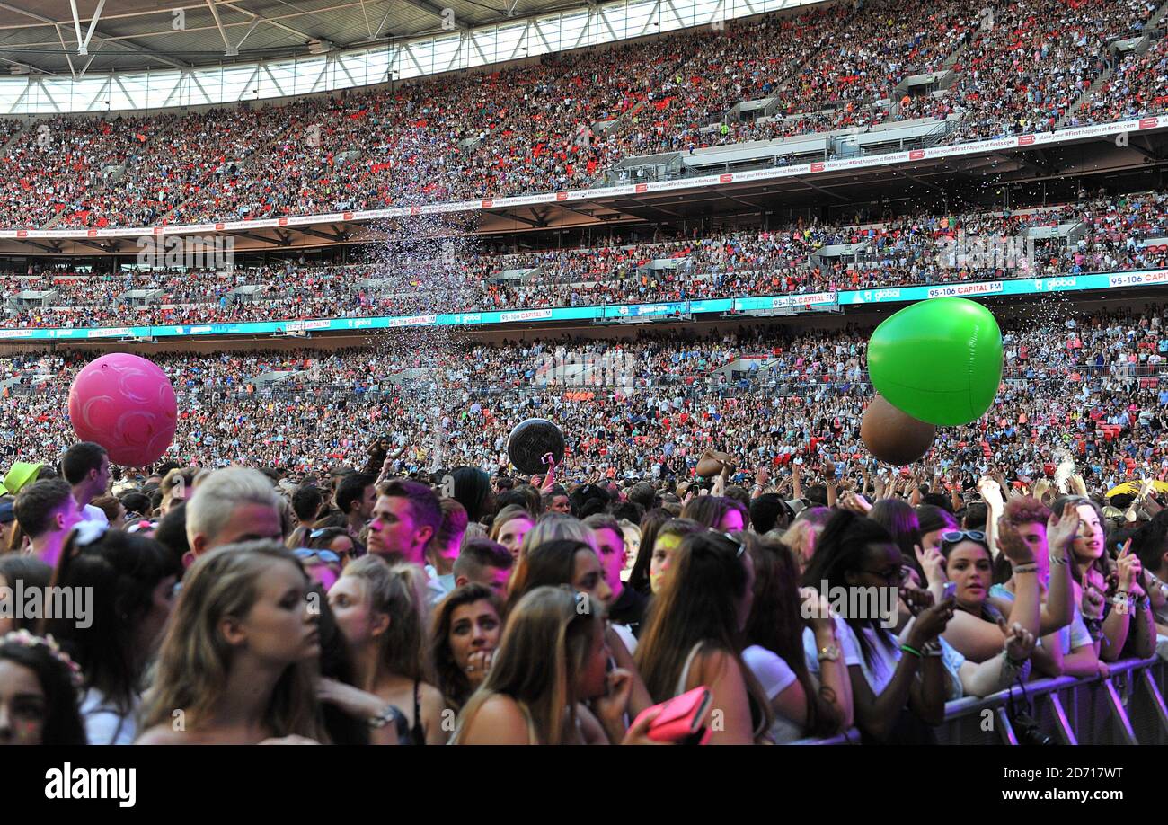 Giant inflatable balloons are passed around the crowd during Capital FM ...