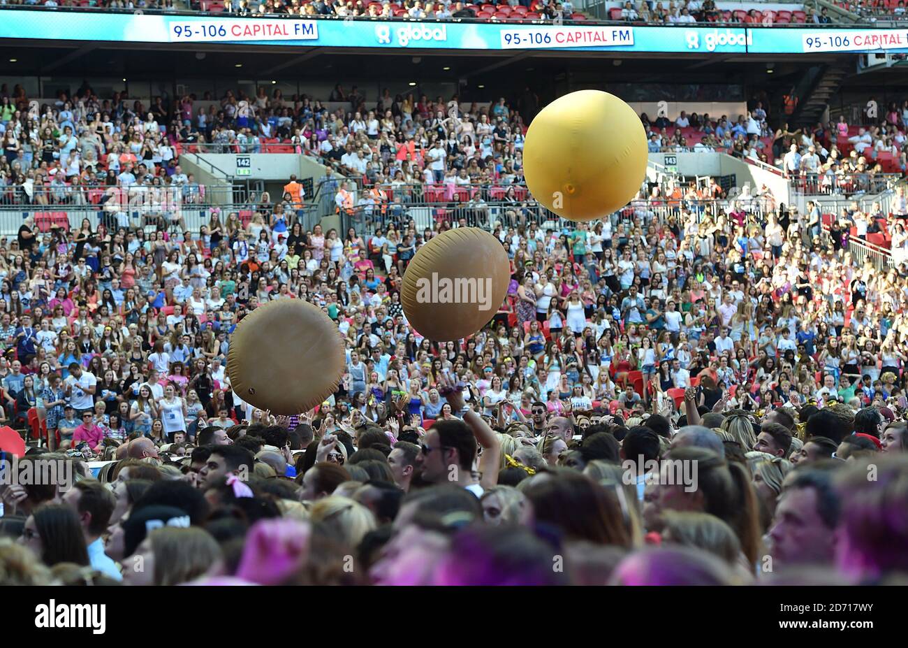 Giant inflatable balloons are passed around the crowd during Capital FM ...