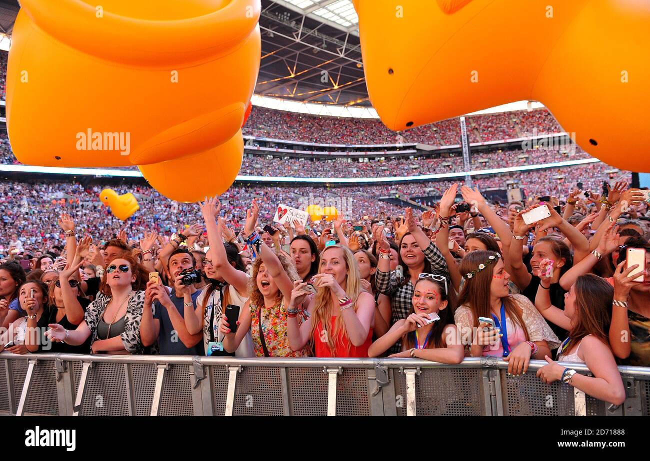 Giant ducks are passed around the crowd as Miley Cyrus performs during ...