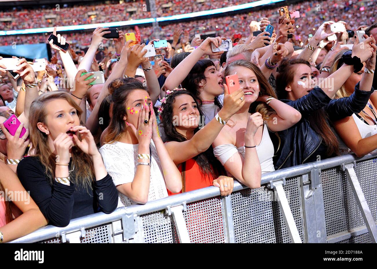 Crowds cheer as Miley Cyrus performs during Capital FM's Summertime ...