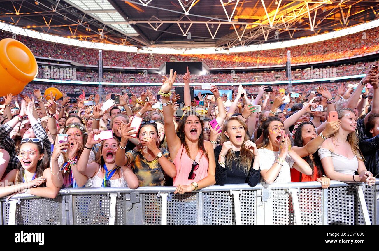 Crowds cheer as Miley Cyrus performs during Capital FM's Summertime ...