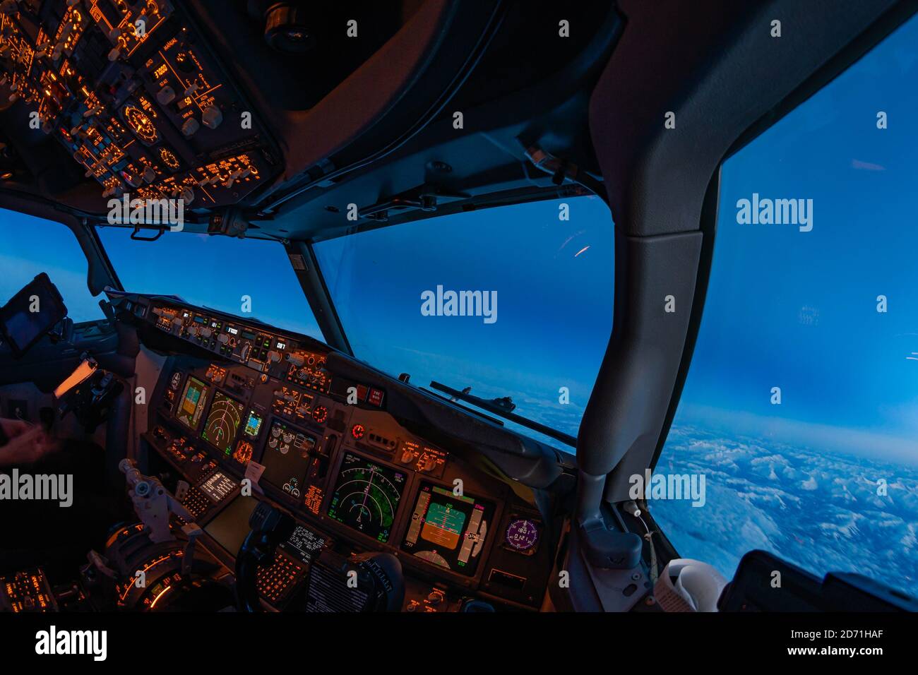 Flight Deck of modern passenger airplane, pilots view in cruise during ...