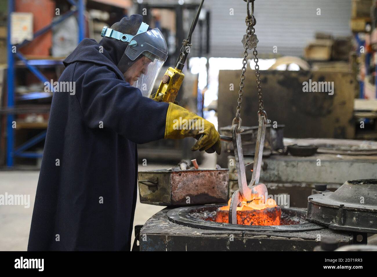 Furnace man Billy Smith heats up bronze for BAFTA masks at a foundry in ...